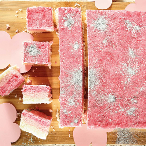 Pink coconut ice squares topped with silver powder | News24